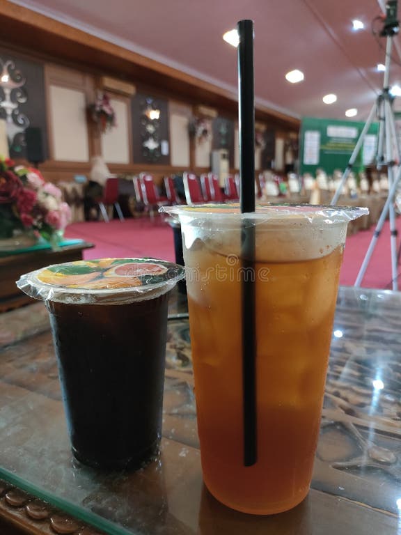 Two Plastic Cups of Different Sizes. a Small Cup of Coffee and a Large ...