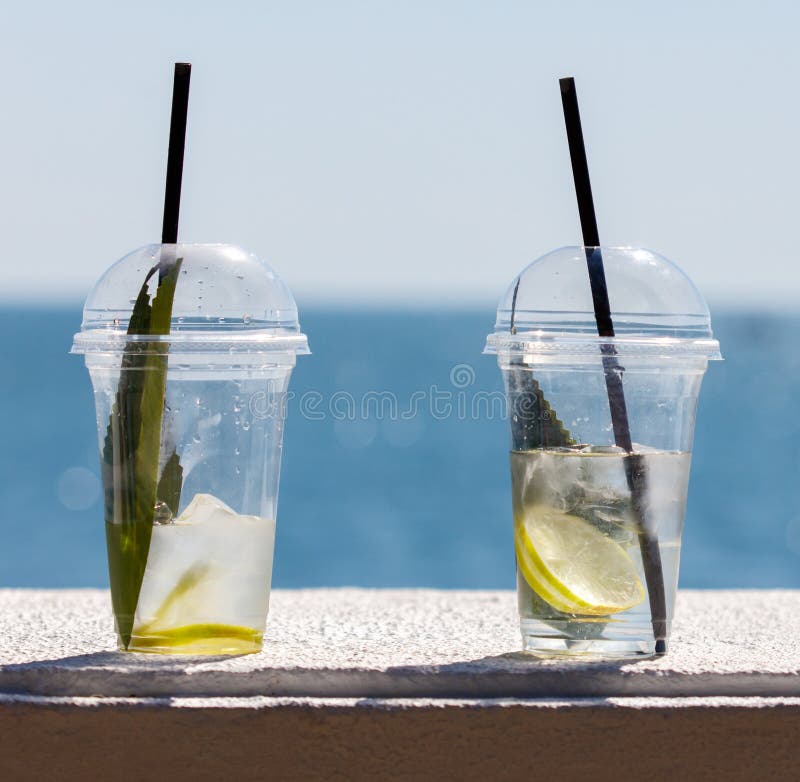 Two Plastic Cups with Straws in Them, One with a Lime Wedge in it Stock ...