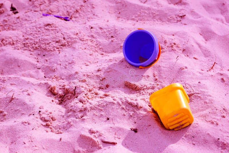 Two Plastic Kid Toys on Pink Sand Stock Photo - Image of childhood ...