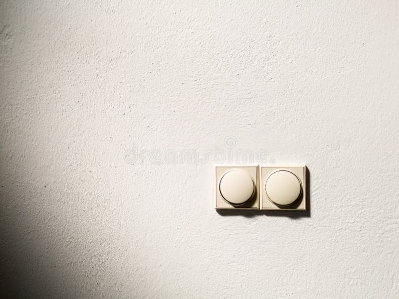 Two Plastic Light Switches on a White Painted Wall in the House in ...