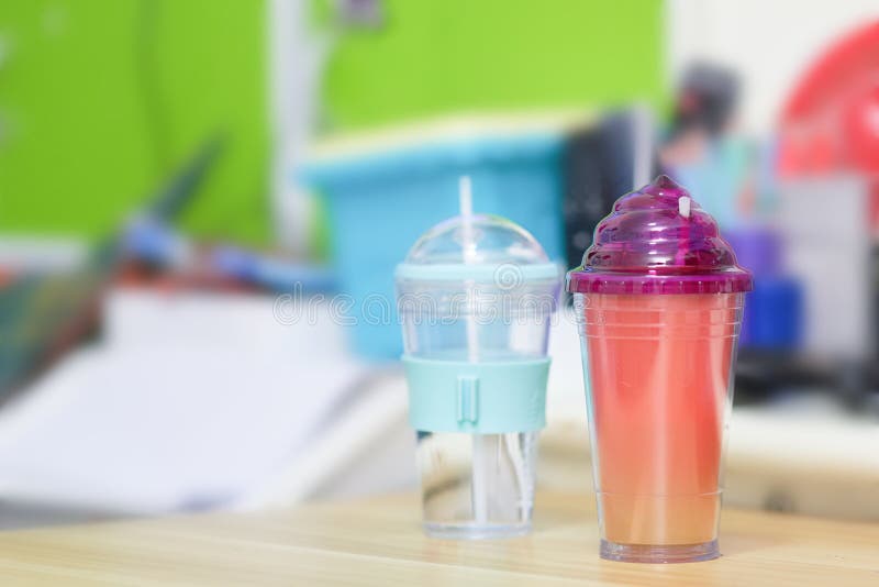 Two Plastic Thermal Preserve Cup Color and Transparent on Table in Room ...