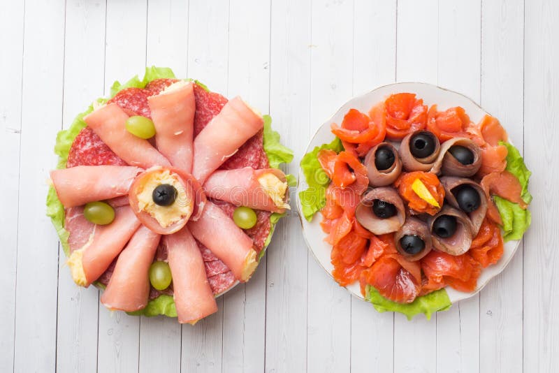 Two Plates of Appetizers. Ham Roll with Cheese and Red Fish Stock Photo ...