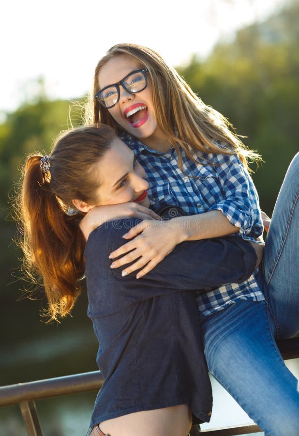 Two Playful Young Women Having Fun Outdoors Stock Photo - Image of ...