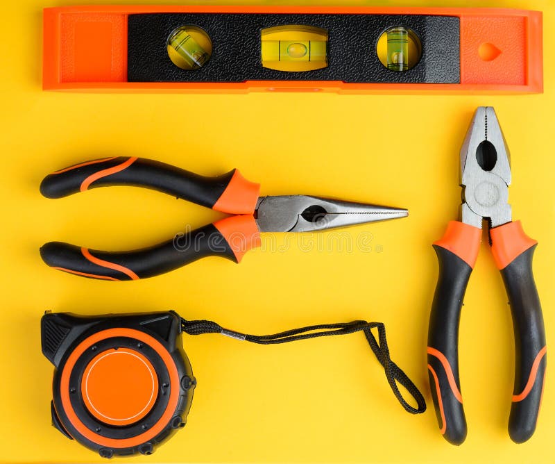 Two Pliers, Tape Measure and Level Tool Top View on Yellow Background ...