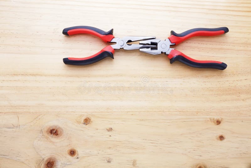 Two pliers on a wood table stock image. Image of handyman - 59807645
