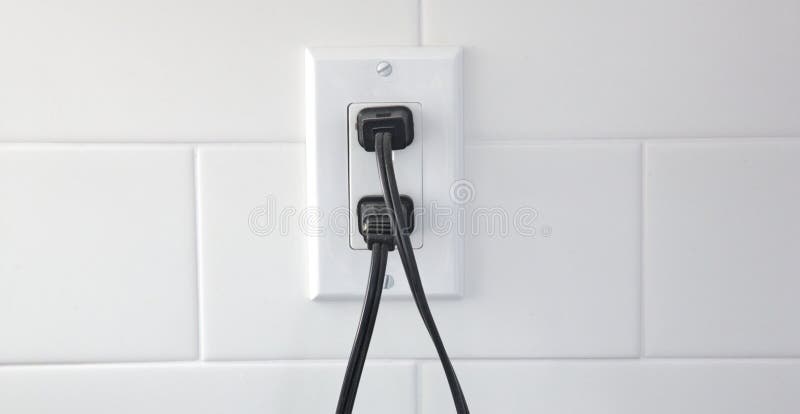 Two Plugs in an Outlet Set Against Tile Stock Image - Image of surge ...