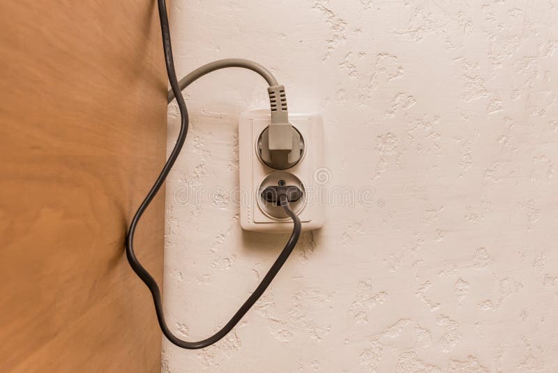 Two Plugs in the Socket in a Modern Interior. Safe Connection of ...