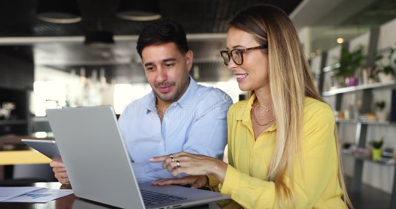 Two Positive Diverse Project Co-workers Working at Laptop Together ...