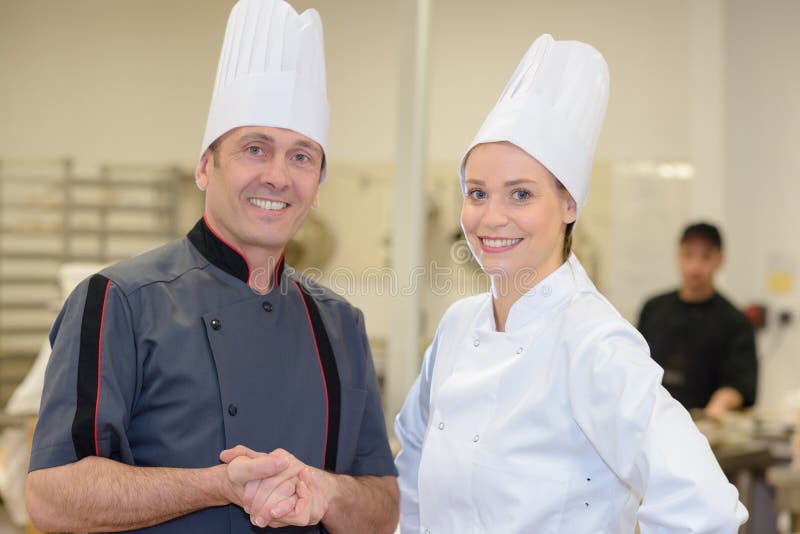 Two Positive Smiling Professional Cooks Working at Restaurant Stock ...