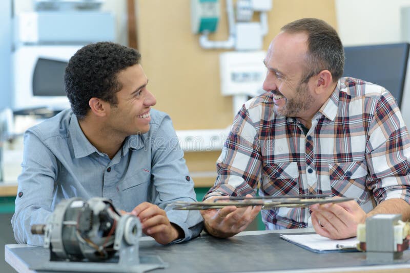 Two Positive Workmen in Workshop Stock Photo - Image of skilled, price ...