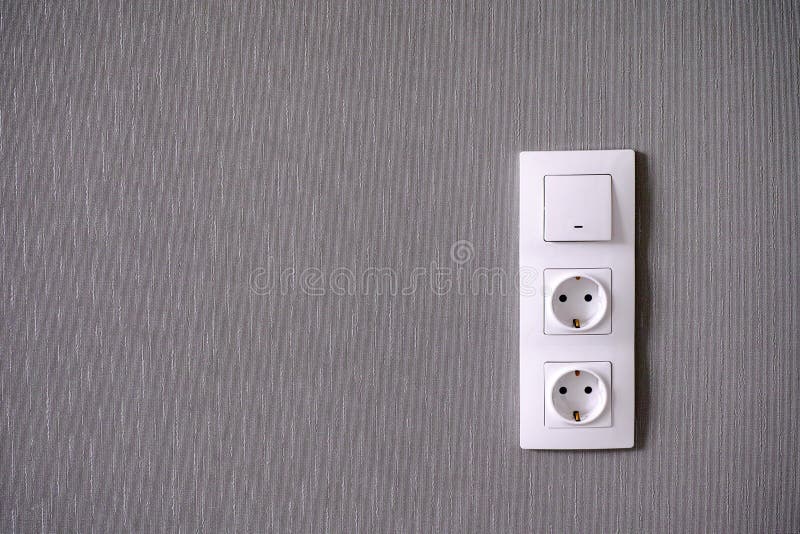 Two Power Sockets and Light Switch on Gray Wall Stock Image - Image of ...
