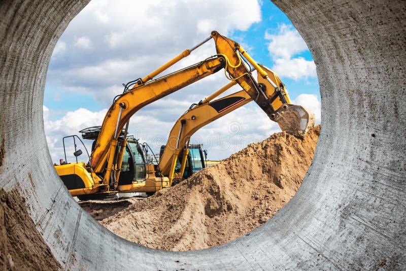Two Powerful Excavators Work at the Same Time on a Construction Site ...