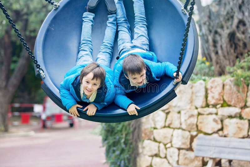 Two Preschool Children in a Swing, Having Fun Stock Image - Image of ...