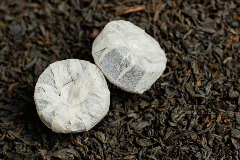 Two Pressed Tea Tablets Wrapped in Wrapping Paper on Background of ...