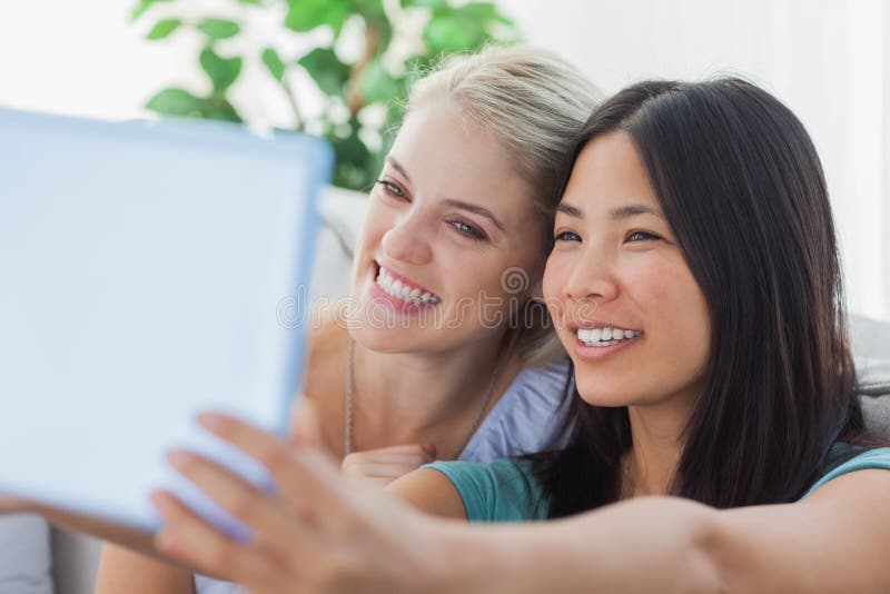 Two Pretty Friends Taking Photo with Tablet Pc Stock Photo - Image of ...