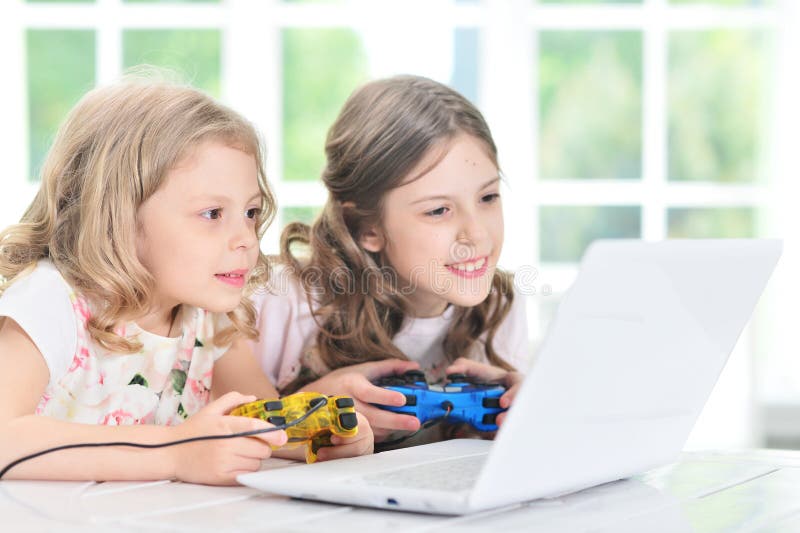 Two Pretty Girls Lying Playing Video Game Stock Photo - Image of girls ...