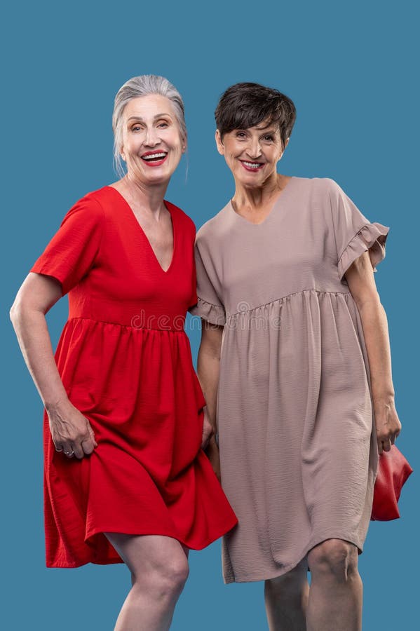 Two Pretty Mature Women in Dresses Looking Happy Stock Image - Image of ...
