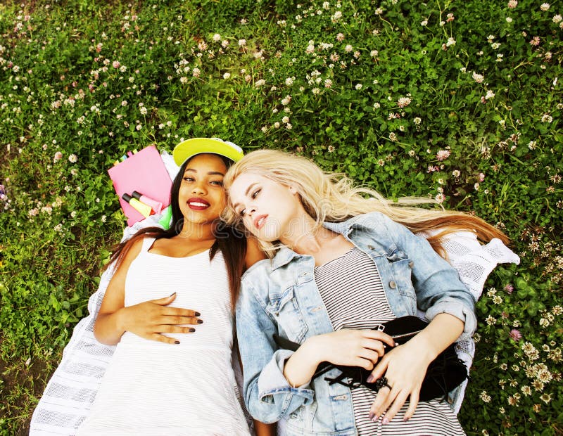 Two Pretty School Girls On Grass Happy Smiling Best Friends Hav Stock