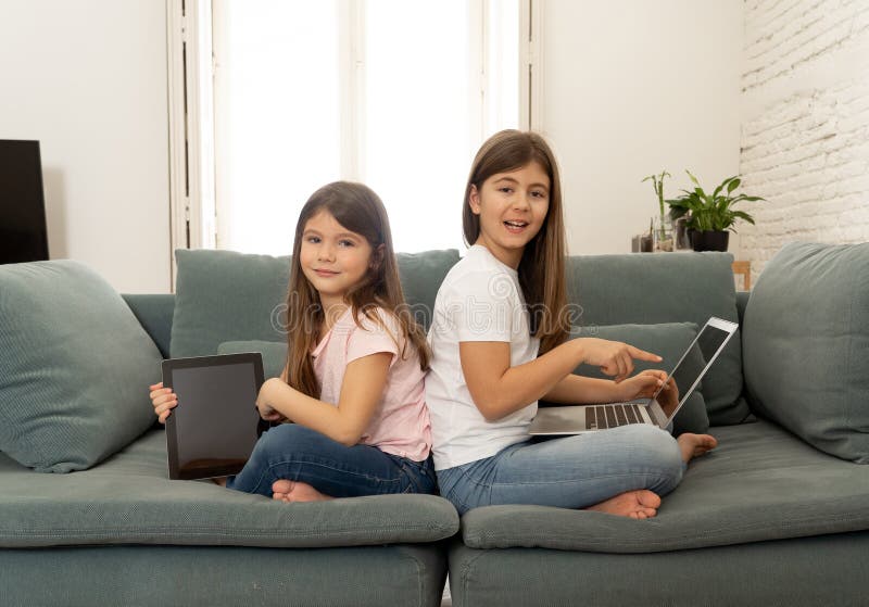 Two Pretty Sisters Having Fun Together Playing And Surfing On Th Stock