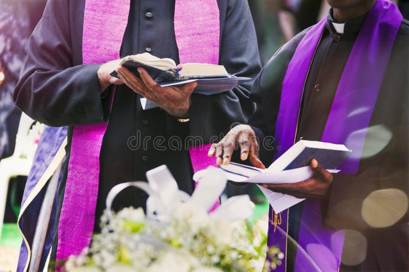 Two Priests Reading Prayers from the Bible at a Funeral Stock Image ...