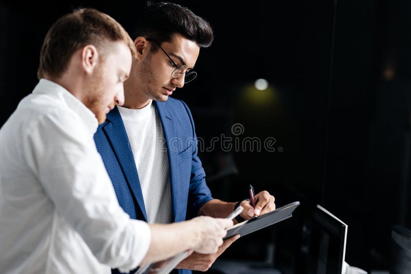 Two Professional Architects Discuss Sheet with Drawing in the Office ...