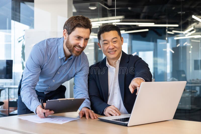 Professional Businessmen Collaborating in an Office Environment Using ...