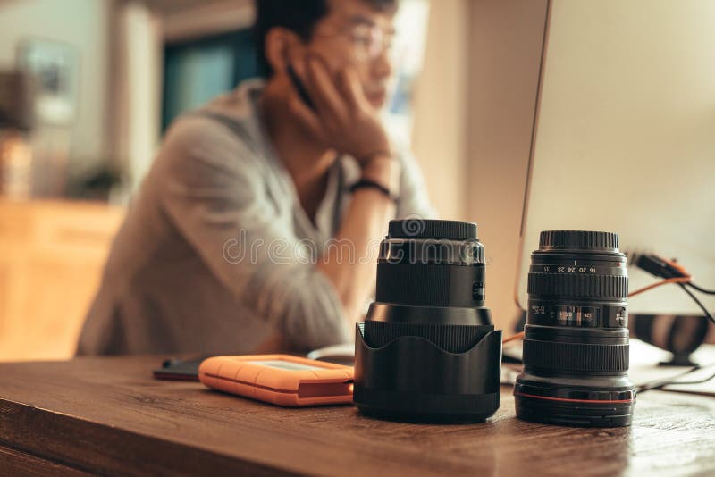 Photographer Editing Photos with Lenses on Table Stock Image - Image of ...