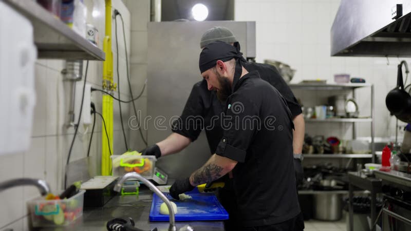 Two Chefs in Black Uniforms Prepare a Dish and Share Their Experience ...