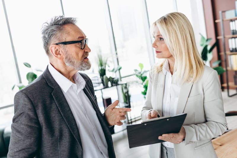 Professional Colleagues Discussing Project Details in Modern Office ...