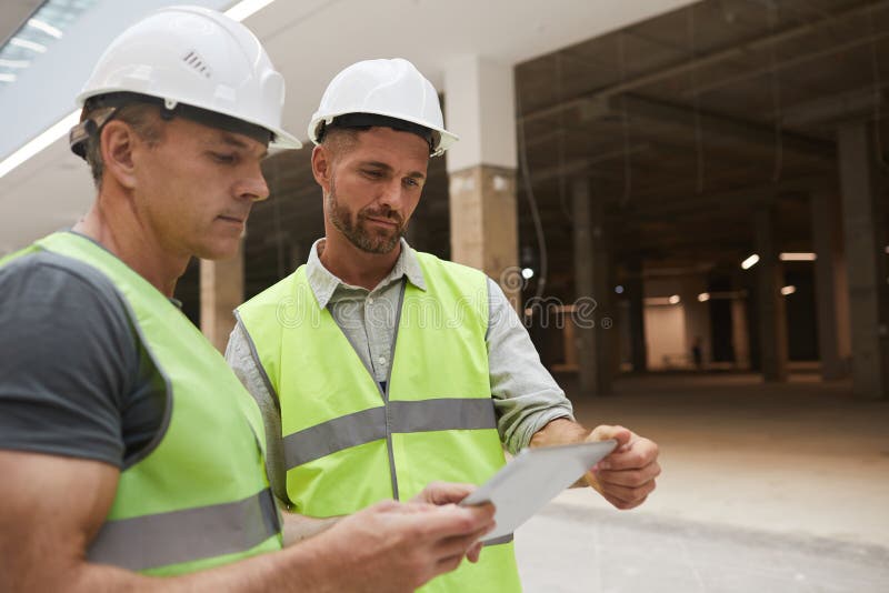 Two Professional Construction Workers on Site Stock Photo - Image of ...
