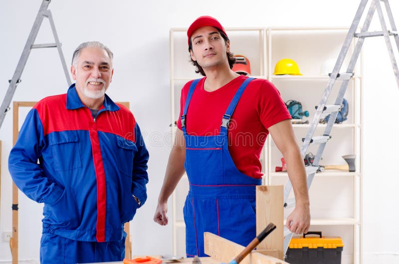 The Two Professional Contractors Laying Flooring at Home Stock Photo ...