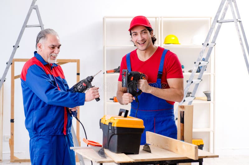 The Two Professional Contractors Laying Flooring at Home Stock Image ...