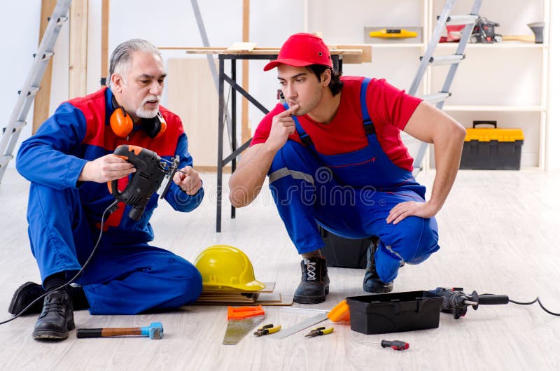 The Two Professional Contractors Laying Flooring at Home Stock Image ...