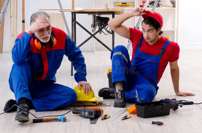 The Two Professional Contractors Laying Flooring at Home Stock Photo ...