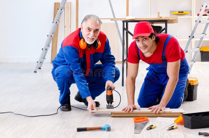 Two Professional Contractors Laying Flooring at Home Stock Image ...