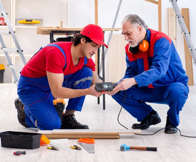 Two Professional Contractors Laying Flooring at Home Stock Image ...