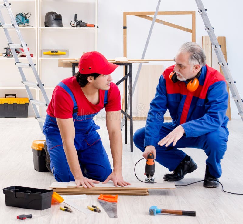 Two Professional Contractors Laying Flooring at Home Stock Image ...