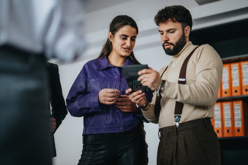 Two Business Colleagues Discussing a Project in an Office Environment ...