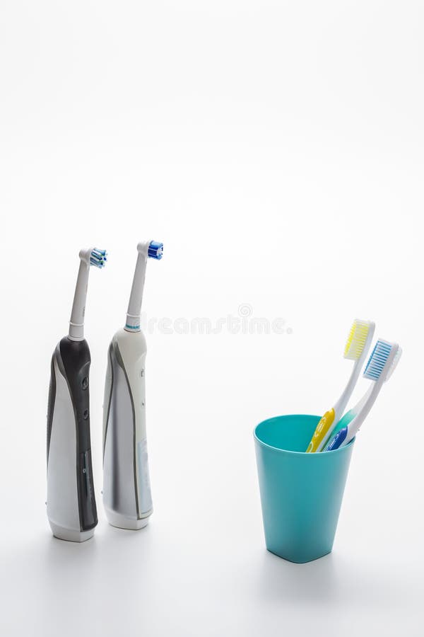 Two Professional Electric Toothbrushes in Front of Four Manual Tooth ...