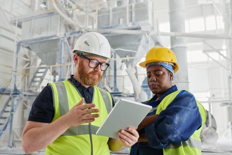 Two Professional Engineers with Tablet Scrolling through Online Manual ...