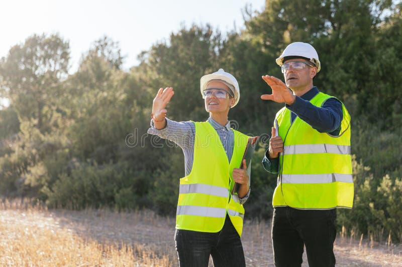 Two Professional Engineers Working Together on a Project in the Field ...