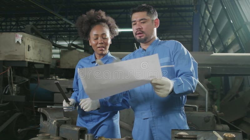 Two Professional Workers Team Working in the Metalwork Manufacturing ...