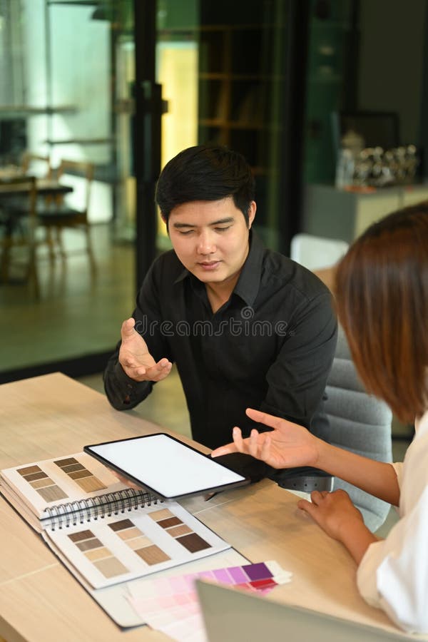 Two Business People Discussing New Project Together in Office. Stock ...