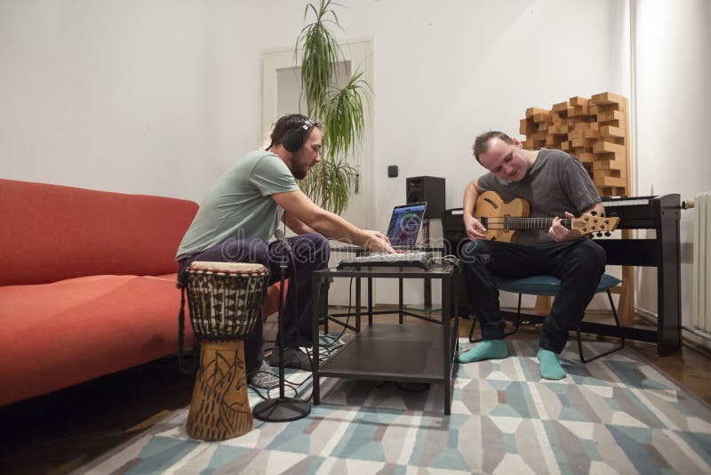 Two Musicians Playing Instruments in Home Music Studio Stock Image ...