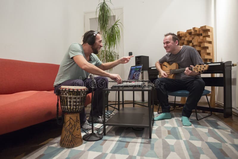 Two Musicians Playing Instruments in Home Music Studio Stock Photo ...