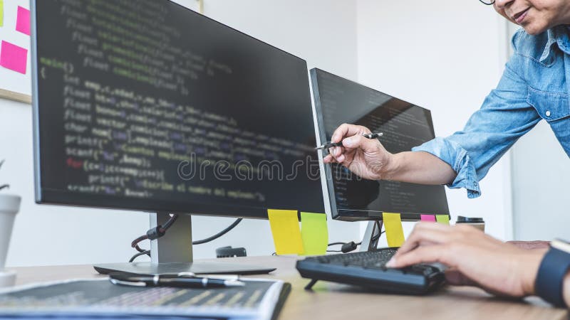 Two Professional Programmers Cooperating At Developing Programming And Website Working In A ...