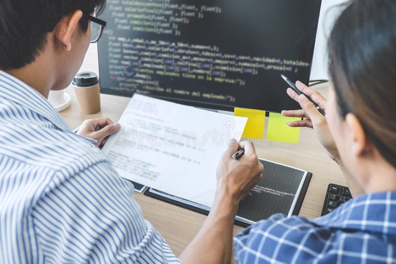 Two Professional Programmers Cooperating At Developing Programming And Website Working In A
