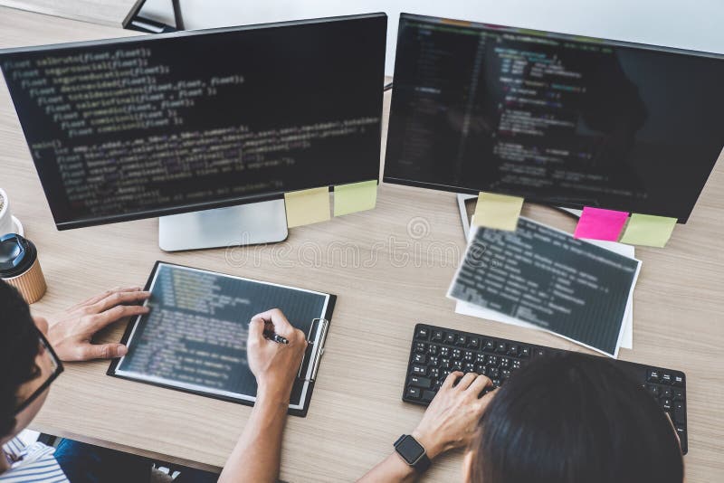 Two Professional Programmers Cooperating At Developing Programming And Website Working In A