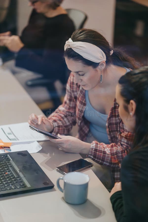 Two Professional Women Brainstorming Over Documents and Digital Devices ...