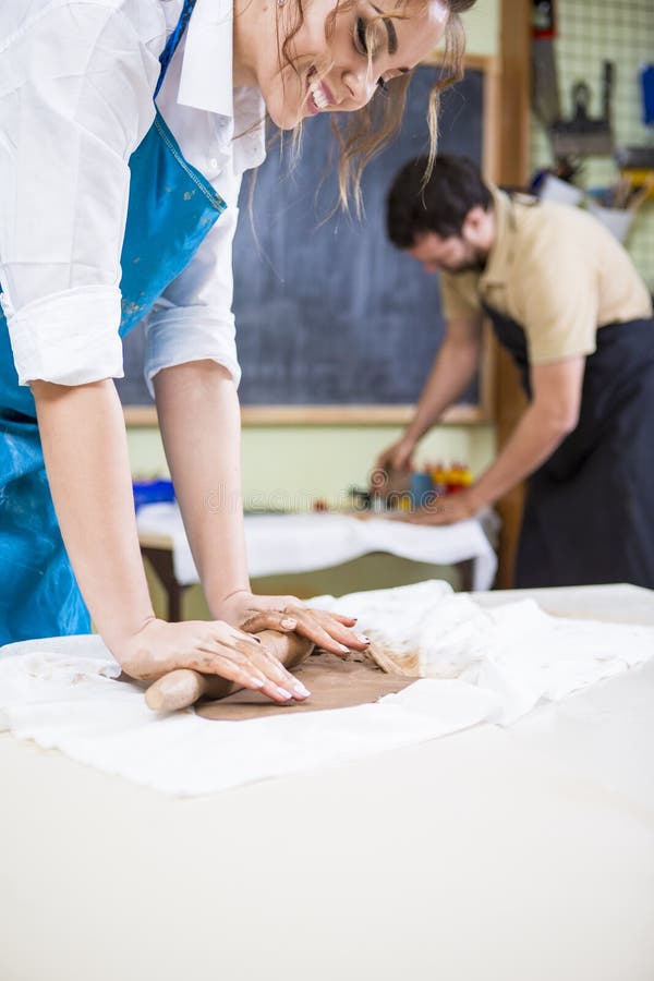 Two Professional Workers Preparing a Clay Pieces on Tables in Workshop ...